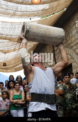 Strong man lifting heavy stone Lebanon Middle East Stock Photo - Alamy