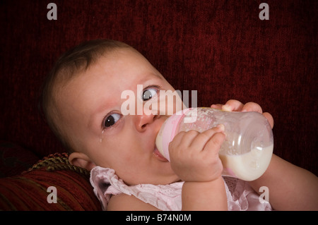 Girl crying while drinking milk Stock Photo - Alamy