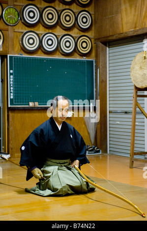 A Kyudoka stringing his bow in a Dojo in Yudanaka, Japan Stock Photo ...
