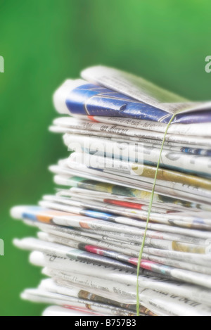 Stack of newspapers tied up with string Stock Photo - Alamy
