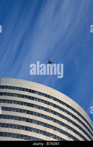 Jet airliner plane airplane over office building in the Dubai Creek, Al ...