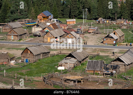 Log cabins at Tuwa village in Kanas National Park in Xinjiang in China ...
