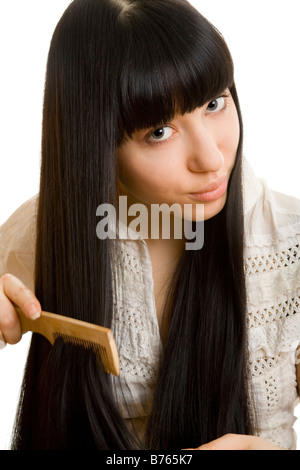 teen girl combing hair isolated on white. teen girl combing hair in ...