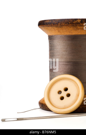 Needle with thread and button isolated on white , needlework and ...