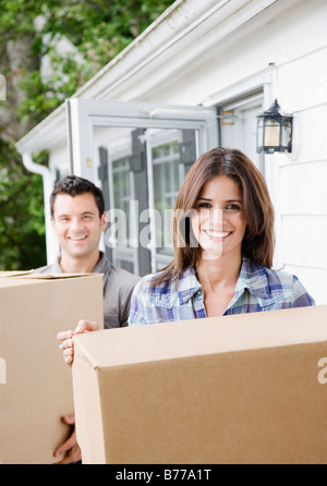 Happy young couple with cardboard boxes in room on moving day Stock ...