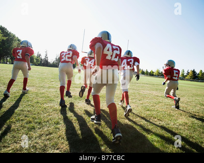 Football players running onto field Stock Photo - Alamy