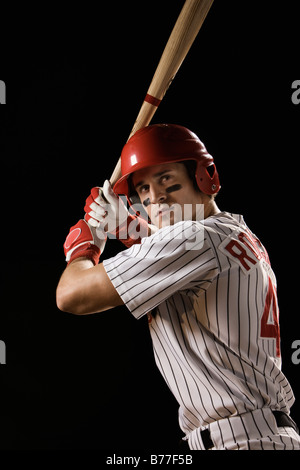 Baseball player posing with bat Stock Photo - Alamy