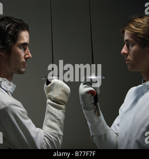 Fencers facing off fencing foils Stock Photo - Alamy