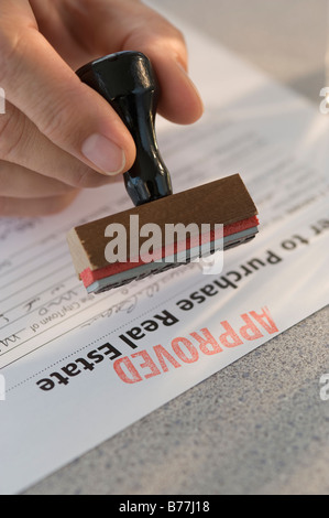 man stamping approval Text is approved by stamping the document on ...