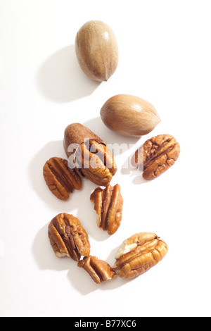 Up close photo of pecans still in their shell on a wood surface Stock ...