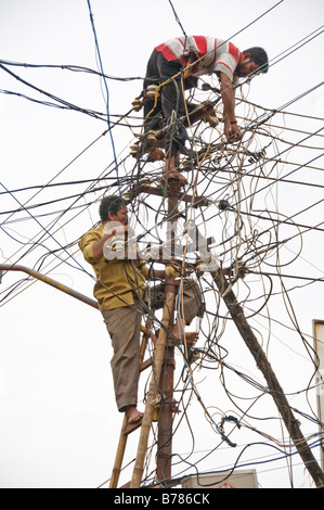 two electrician workers at wiring cable and light switch Stock Photo ...