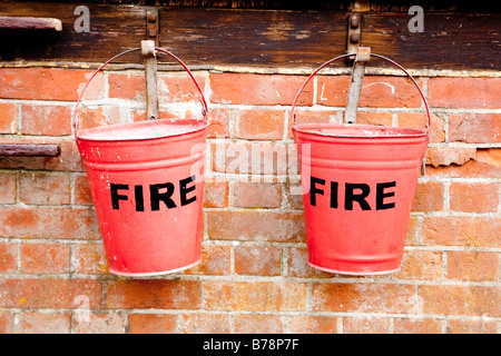 Red fire buckets filled with sand Stock Photo - Alamy