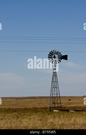 Kansas Country Windmill with Blue sky and clouds with wheat. In a field ...