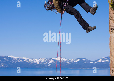 Man rappelling off a cliff, Lake Tahoe, Nevada, USA Stock Photo - Alamy