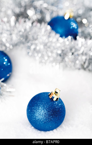 Blue Christmas balls in the snow Stock Photo - Alamy