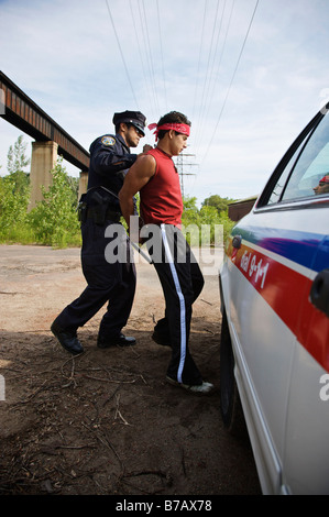 Police officer arresting suspicious young car driver Stock Photo - Alamy