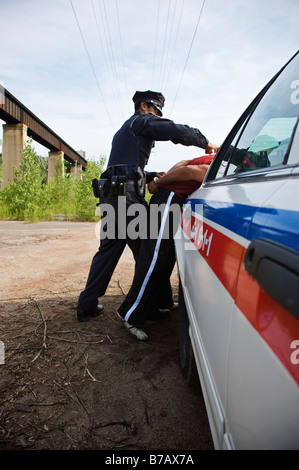 Police officer arresting suspicious young car driver Stock Photo - Alamy