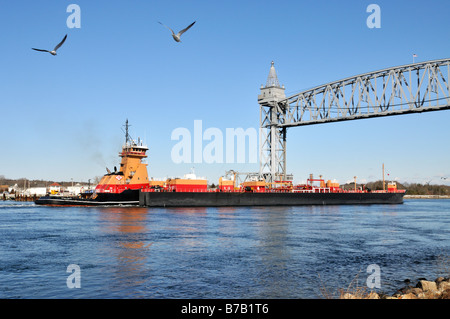 A push boat tug with a barge and a bridge on the Mississippi River in ...