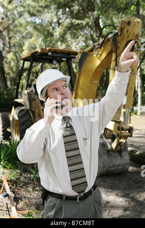 Construction foreman giving orders on bullhorn isolated on white ...