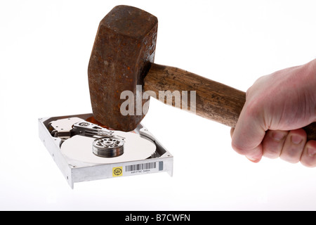 mans hand holding old sledge hammer over a computer hard drive on white ...