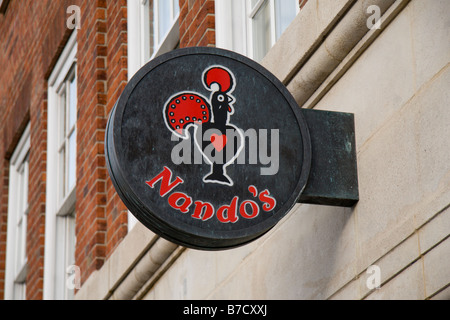 Nando's sign and logo above the restaurant in Clink Street, London ...