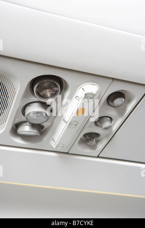 A close up of the overhead panel of a commercial airplane, with ...