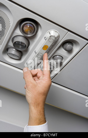 Finger pushing a button on a console. Operational management. Quality ...