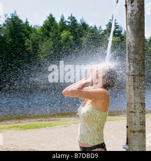 Woman showering outdoors Stock Photo - Alamy