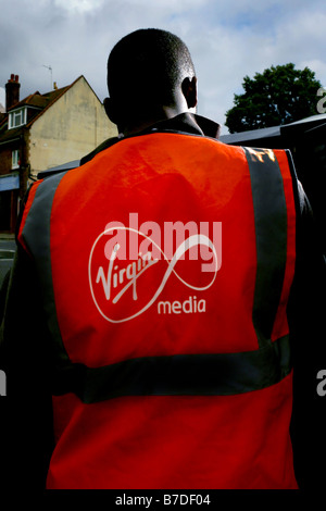 A Virgin Media engineer connecting a telephone service to a property in ...