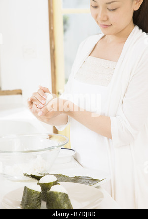 A woman making rice balls Stock Photo - Alamy