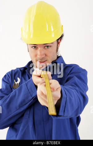Construction worker taking aim Stock Photo - Alamy