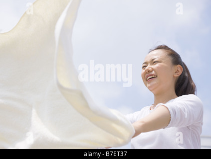 A woman spreading out laundry Stock Photo - Alamy