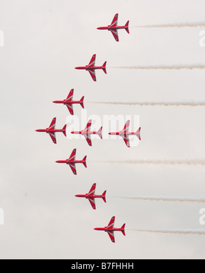 Red arrows hawks display team in arrow formation trailing white - blue ...