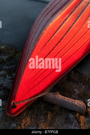 Upturned moored fiberglass red rowboat ( skiff / dinghy Stock Photo - Alamy