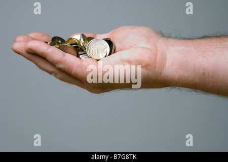 man's hand saving money, euro in piggy bank Stock Photo - Alamy