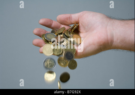 Euro coins falling from a mans hand. Money being thrown away. Money ...