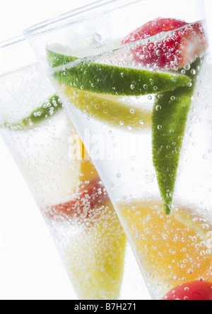 Fresh cut lemon in soda water with bubble on yellow background. Healthy ...