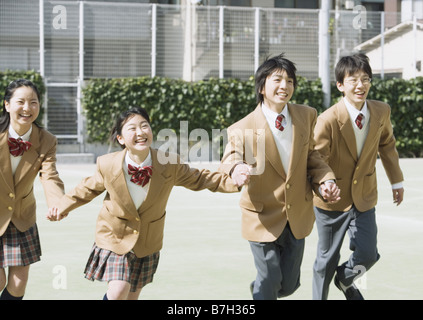 Group of students running in athletic field Stock Photo - Alamy
