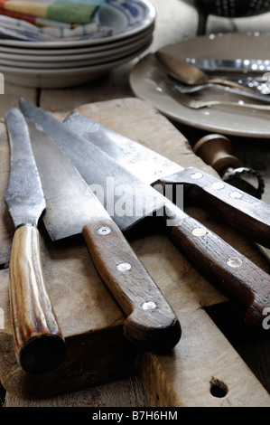 selection of old or antique cooking utensils hanging on a rack in a ...