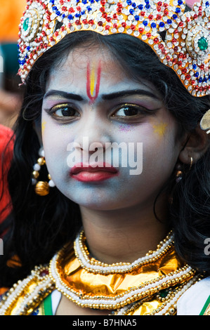 A devotee dressed up as the Hindu god Hanuman, poses for photos during ...