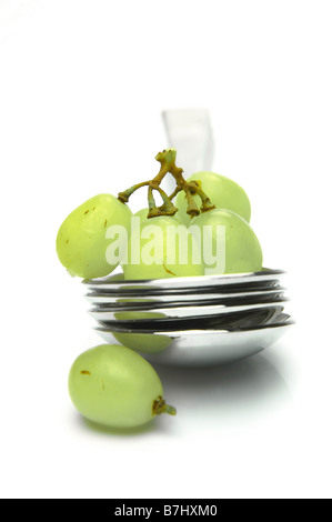 Grapes on a spoon isolated against a white background Stock Photo - Alamy