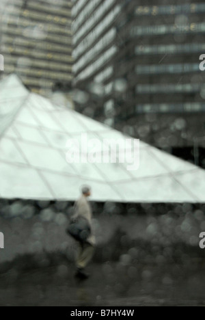 A man seen walking in rain and tander storm disrupted commute. (Photo ...