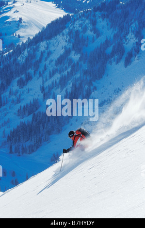 Young male skier skiing untracked slope at Lake Louise Ski Resort ...