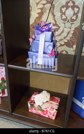 Beautifully wrapped gifts and flowers in the background. Special ...