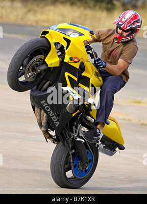 stunt rider mono wheelie motor bike action cycle upright Stock Photo ...