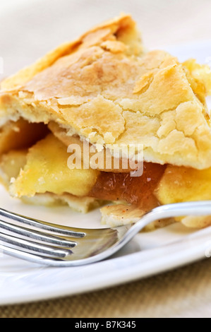 fresh baked apple pie slice on rustic table setting with ingredients ...