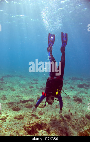 Diver in handstand on diving platform Stock Photo - Alamy