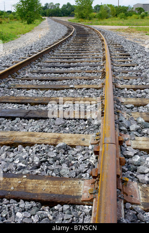A vertical shot of the empty train tracks alongside the forest in Banff ...