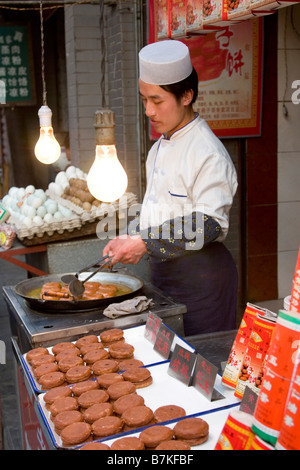 Young cook cooking cakes in the kitchen Stock Photo - Alamy