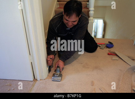united kingdom a carpet fitter at work Stock Photo - Alamy